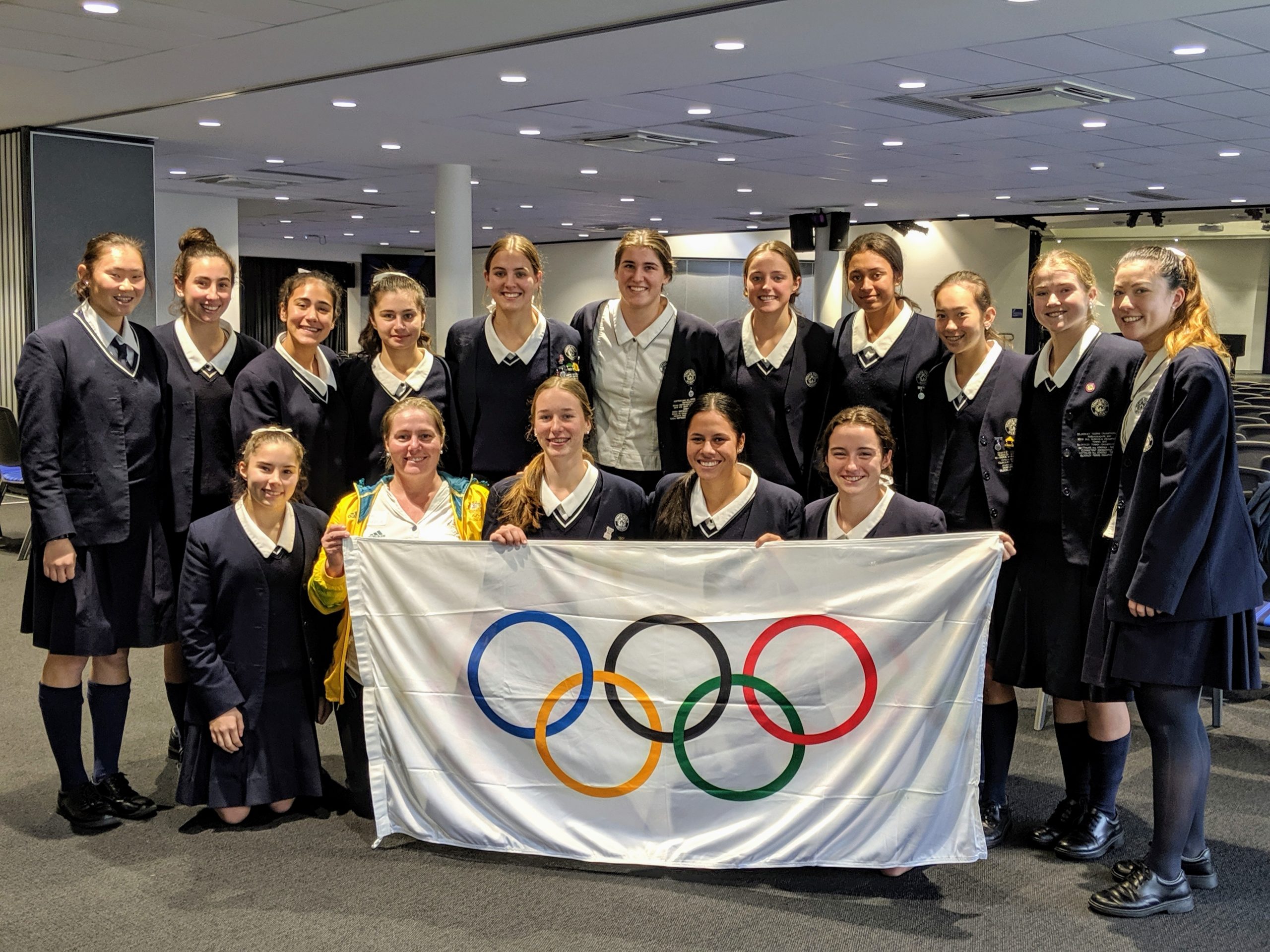 2019_Sport_Olympics_Students in uniform holding olympic flag | Meriden